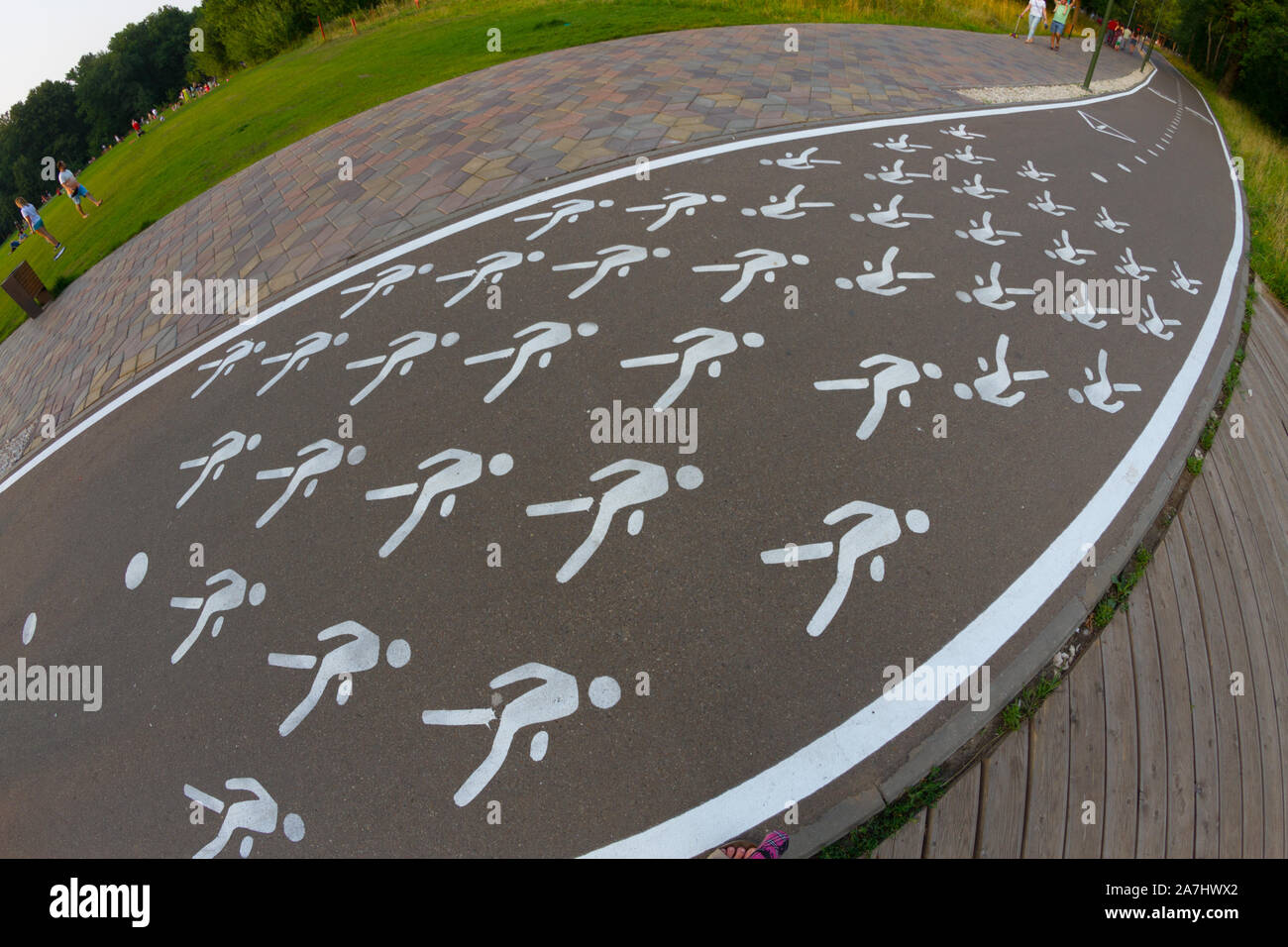 Crosswalk in a park with walking people sign Stock Photo - Alamy