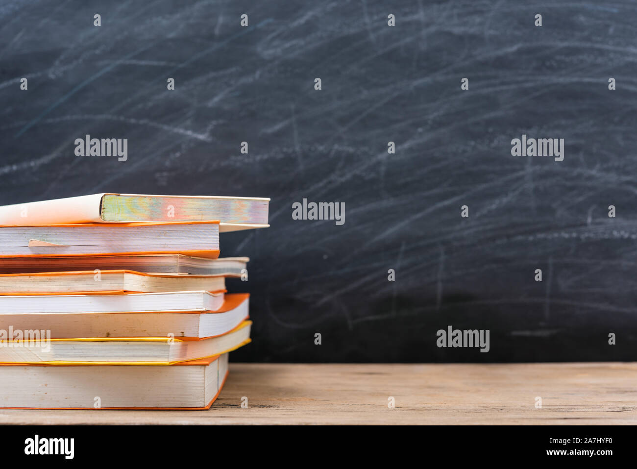 Classroom, with stack books on table have blackboard and chalkboard on ...