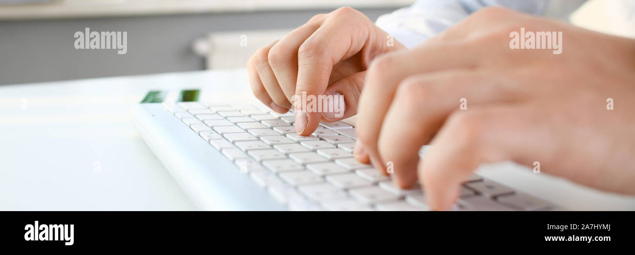 Male arms in suit typing on silver keyboard Stock Photo - Alamy