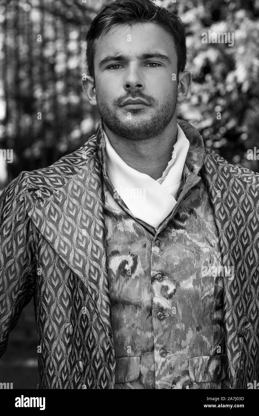 Portrait of attractive gentleman dressed in vintage costume standing in ...