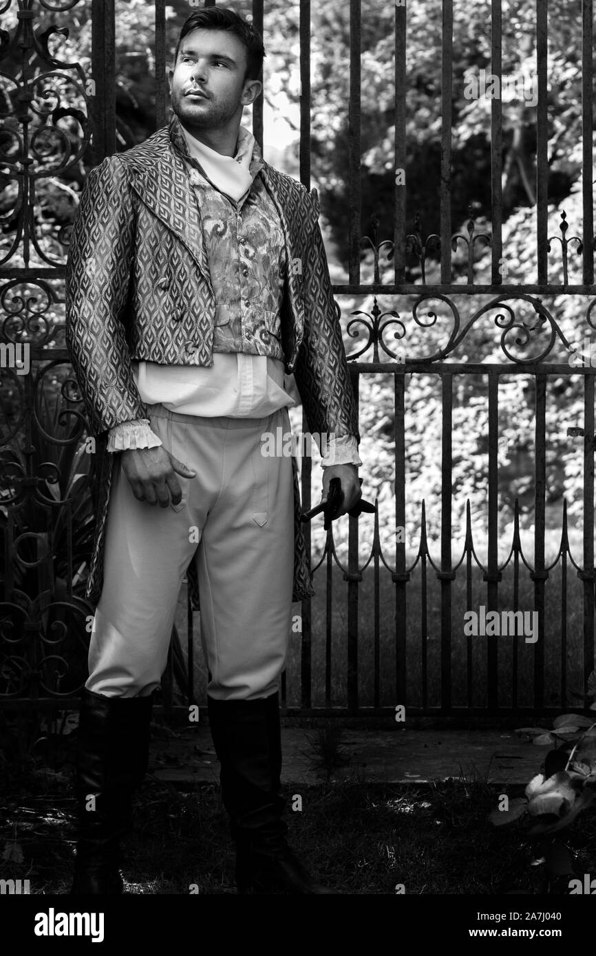 Portrait of attractive gentleman dressed in vintage costume standing in ...