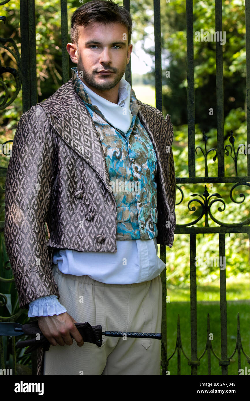 Portrait of attractive gentleman dressed in vintage costume standing in ...