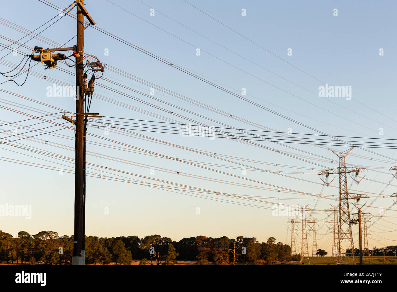 Power line connecting interstate power pylons during golden hour Stock ...