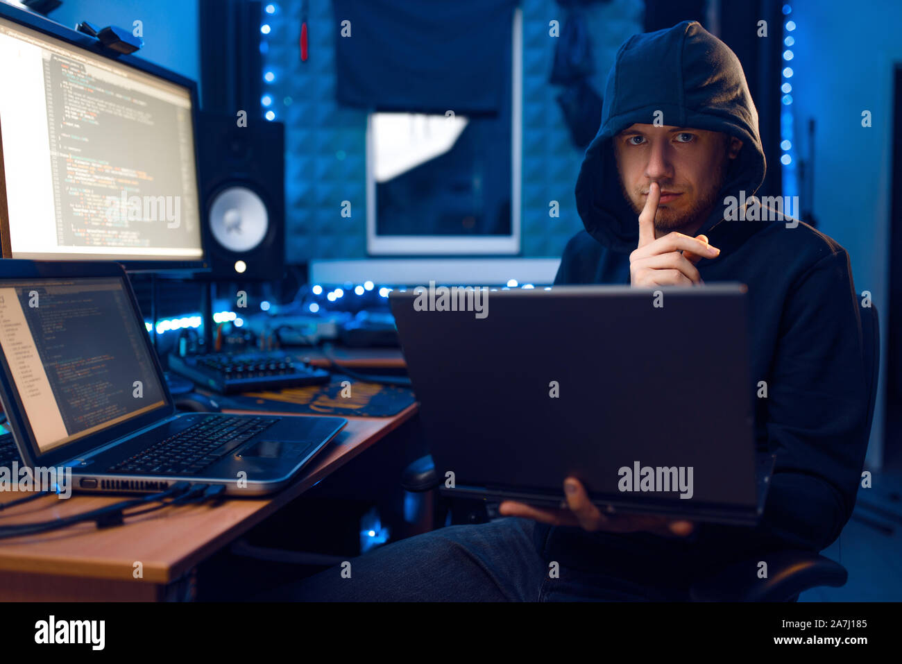 Hacker in hood shows thumbs up, network criminal Stock Photo - Alamy