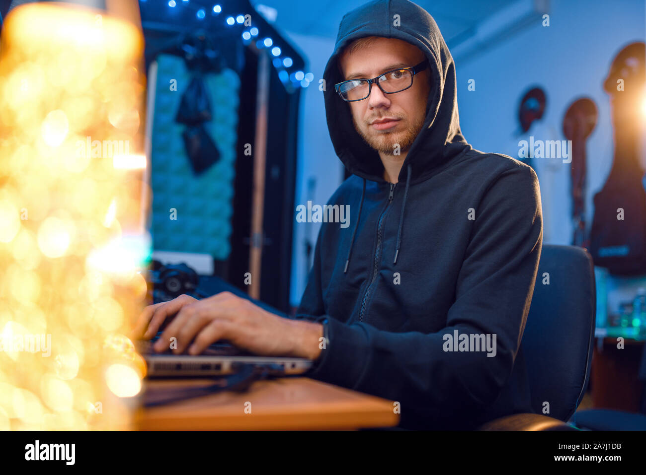 Hacker in hood at his workplace, corporate hacking Stock Photo - Alamy