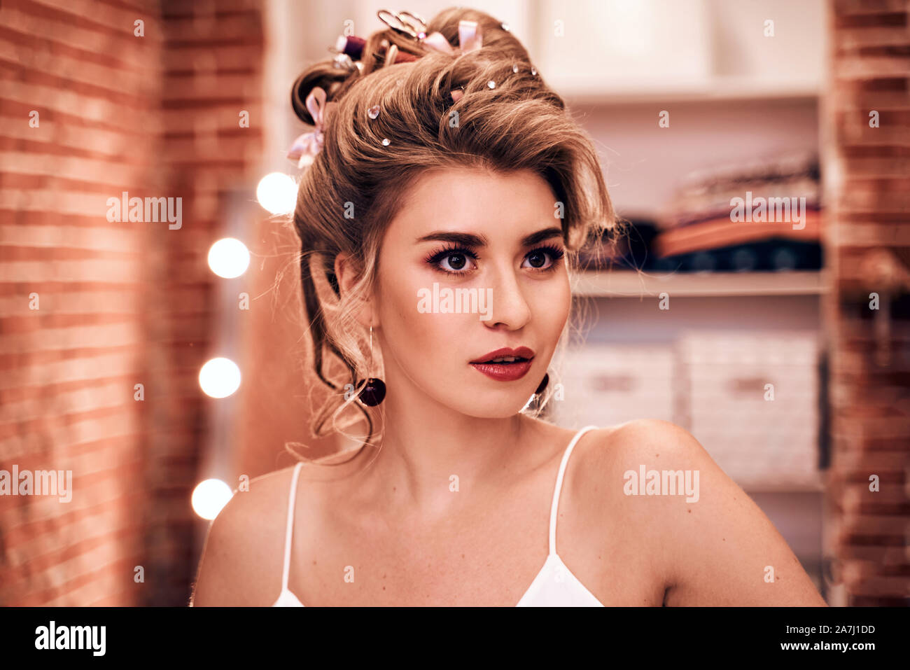 Blonde girl seamstress with creative hairdo Studio Stock Photo - Alamy