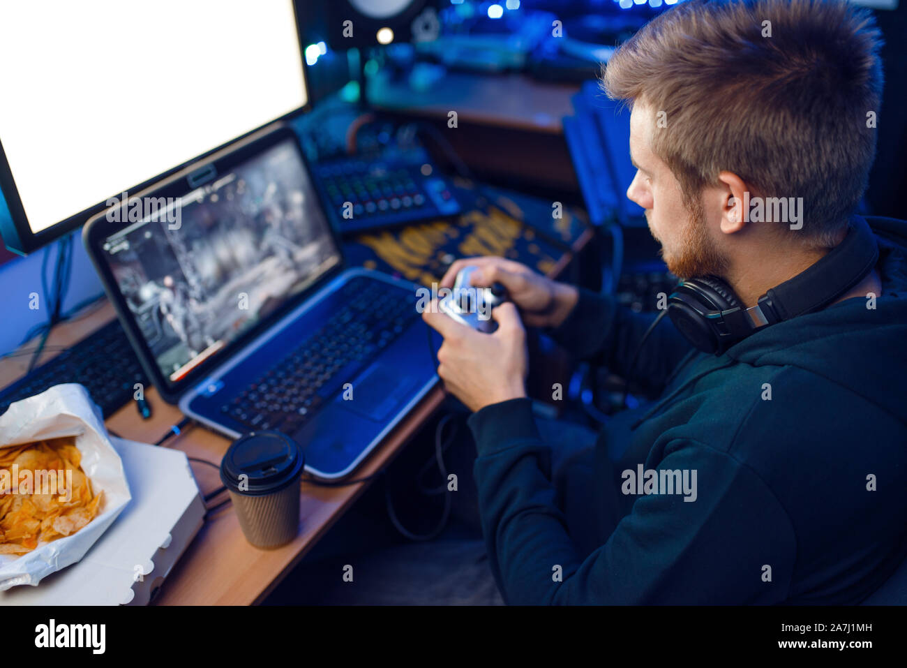 Gamer with joystick playing videogame on console Stock Photo - Alamy