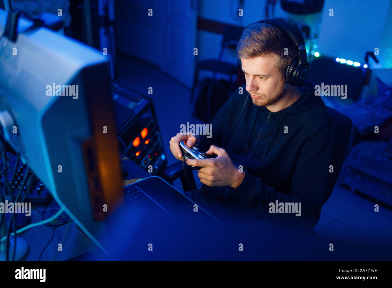 Gamer with joystick playing videogame on console Stock Photo - Alamy