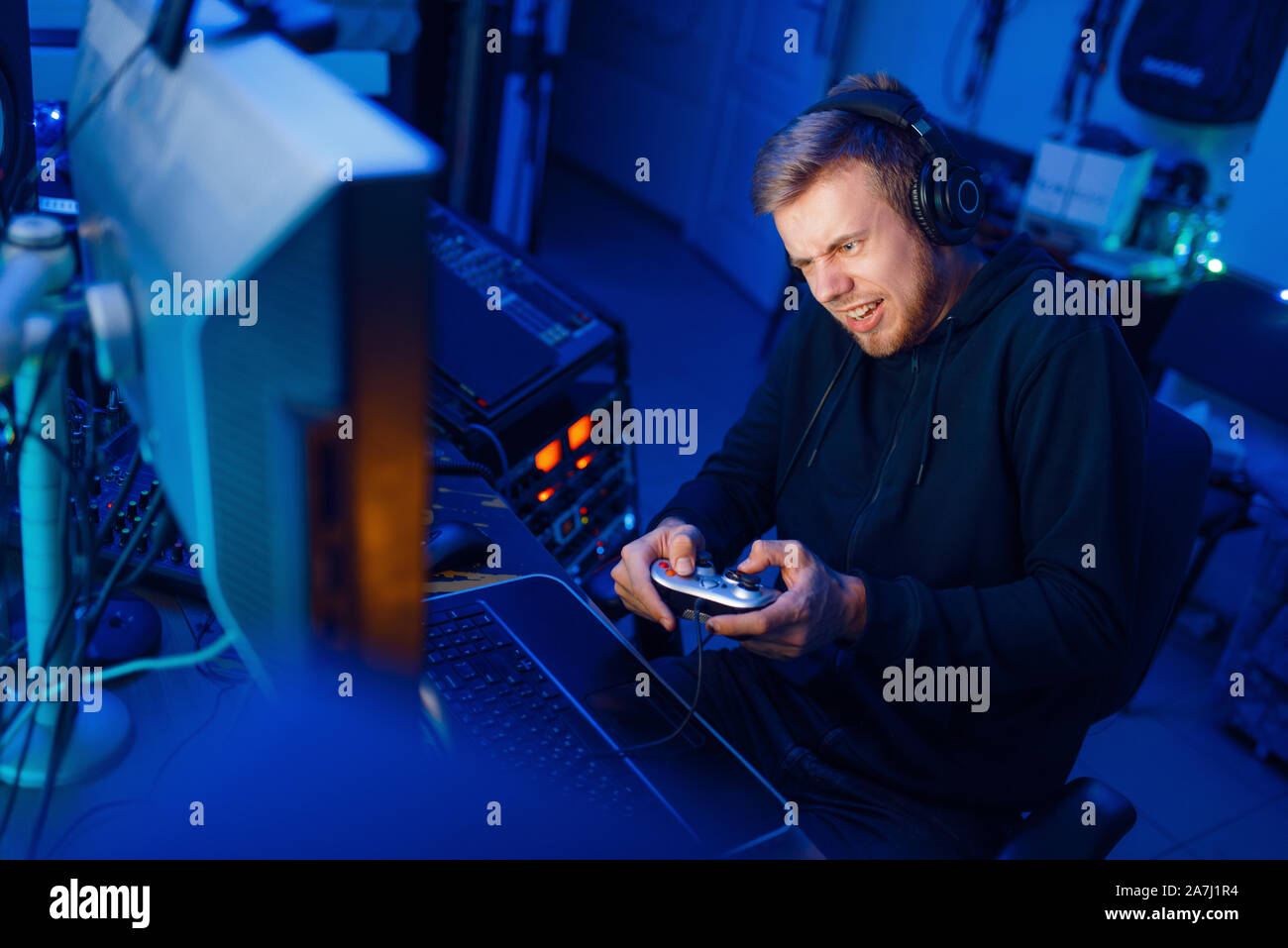 Gamer with joystick playing videogame on PC Stock Photo - Alamy