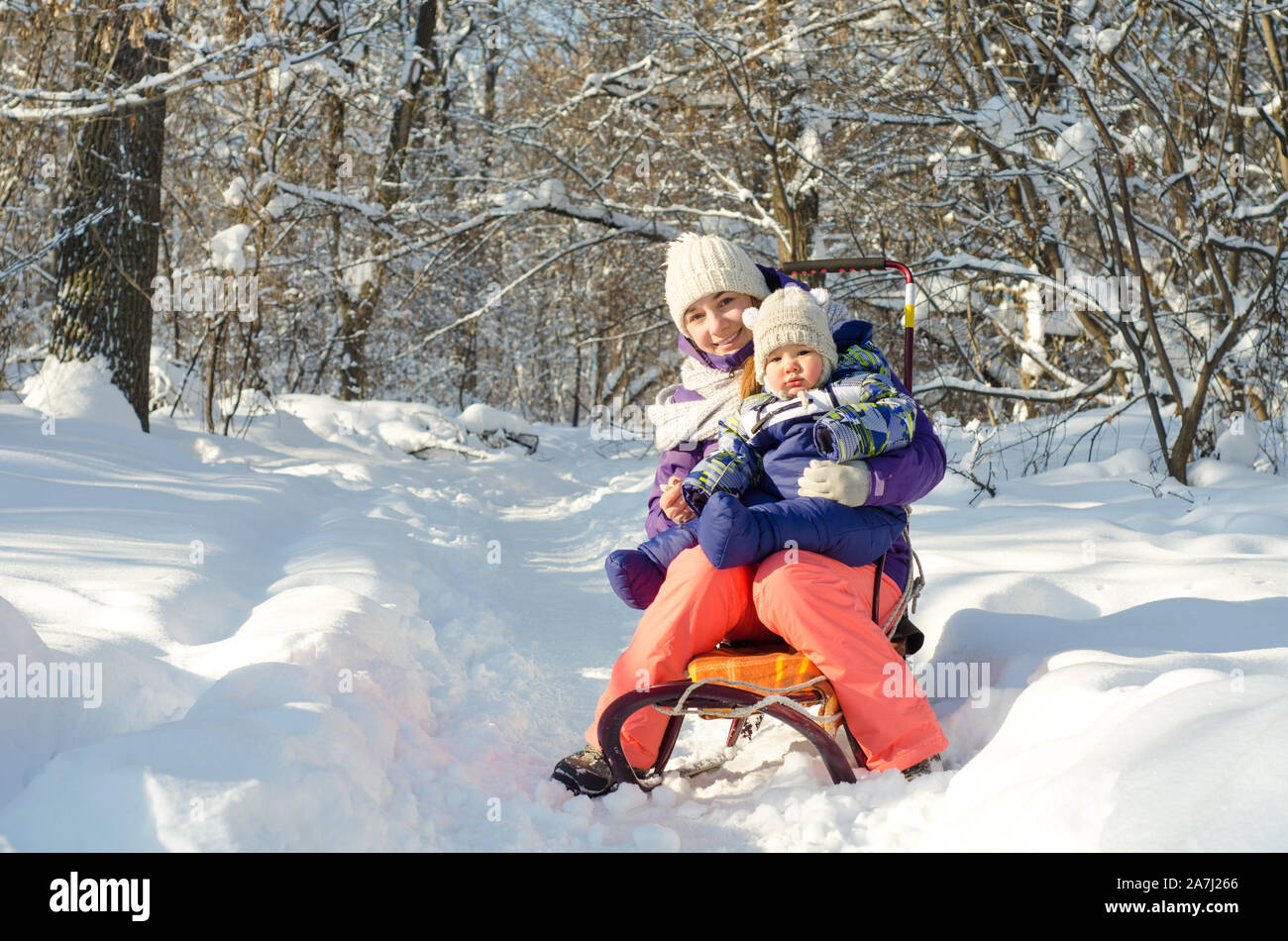 mother and baby sitting on the sledge Stock Photo - Alamy