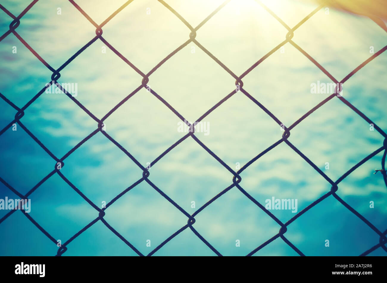 sunshine at sea behind the grid Stock Photo - Alamy