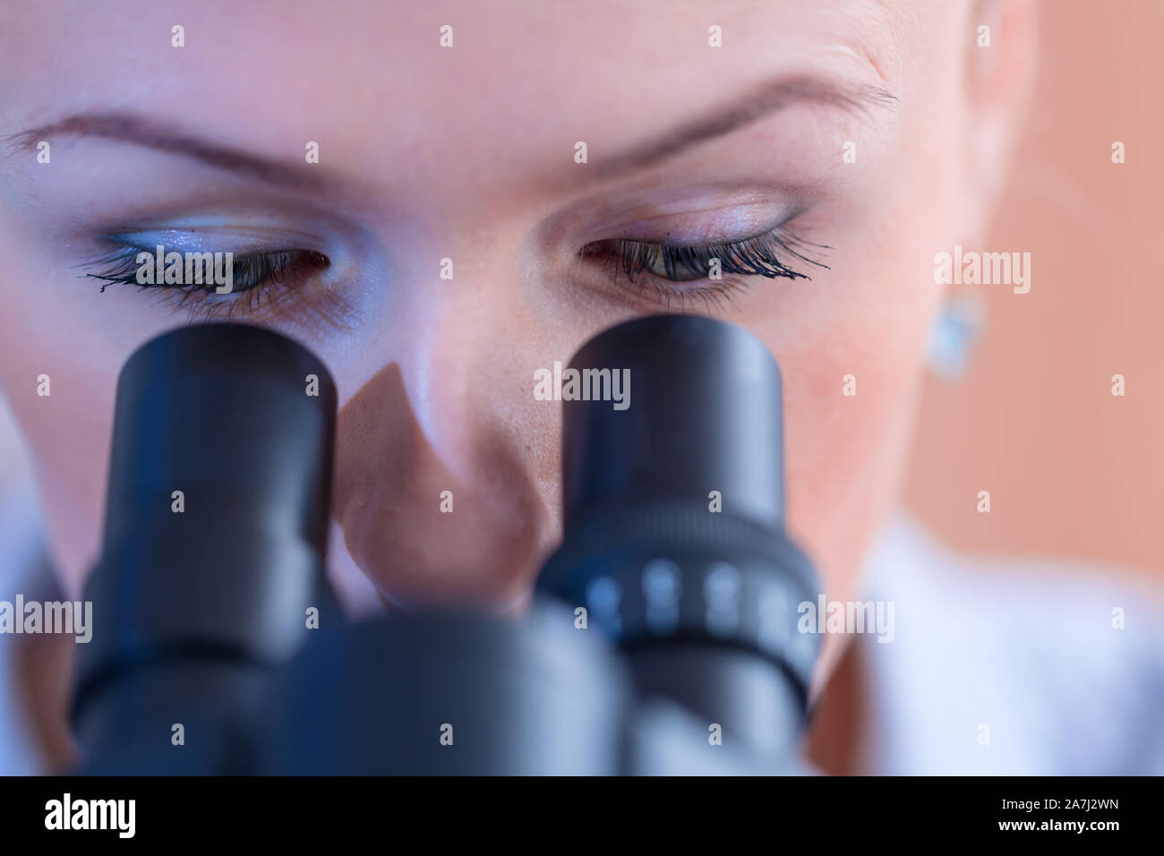 Girl with a slide for the microscope University Hospital. Attractive ...