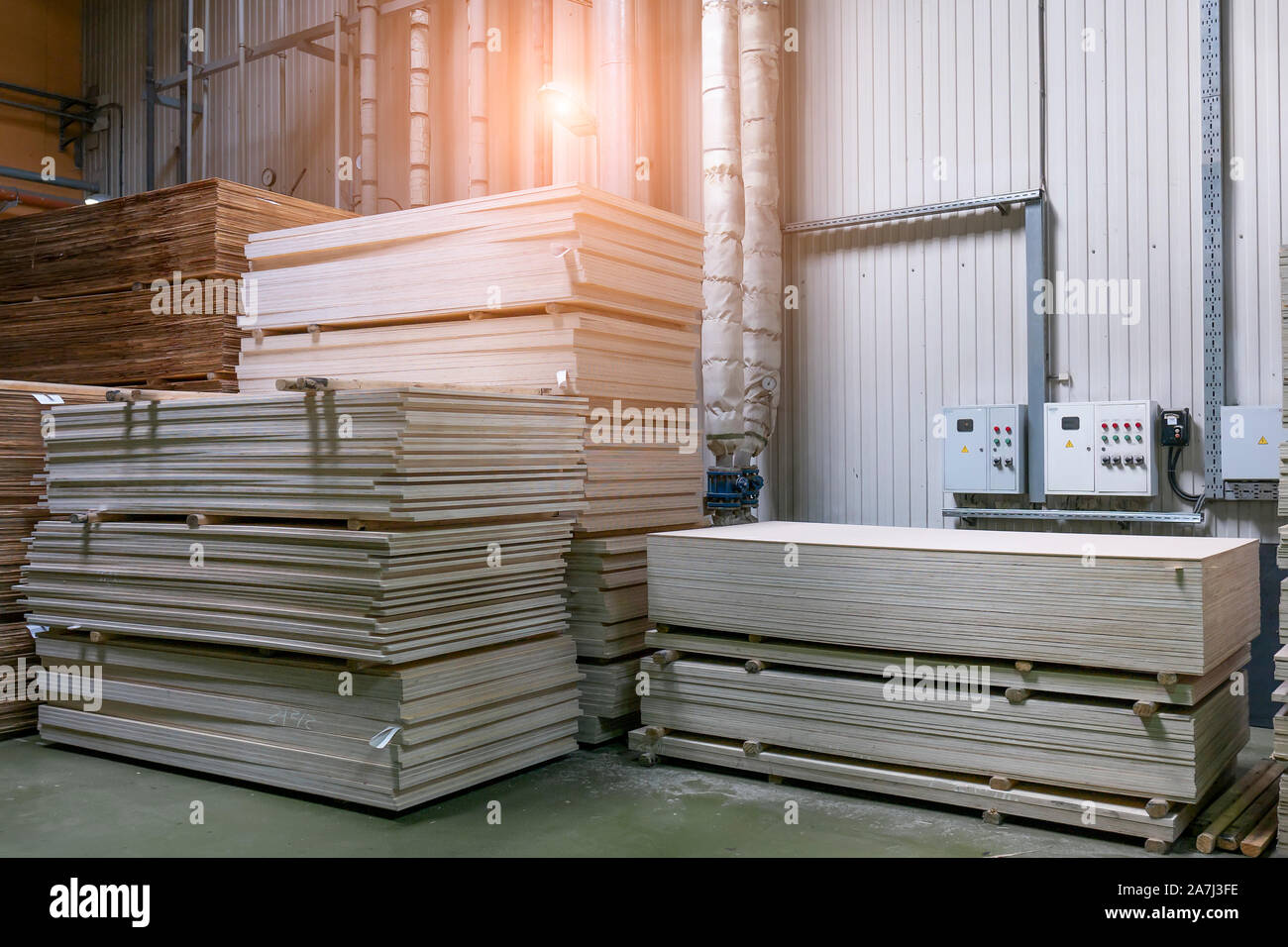 Stacked plywood and wooden board products against de-focused blurred ...