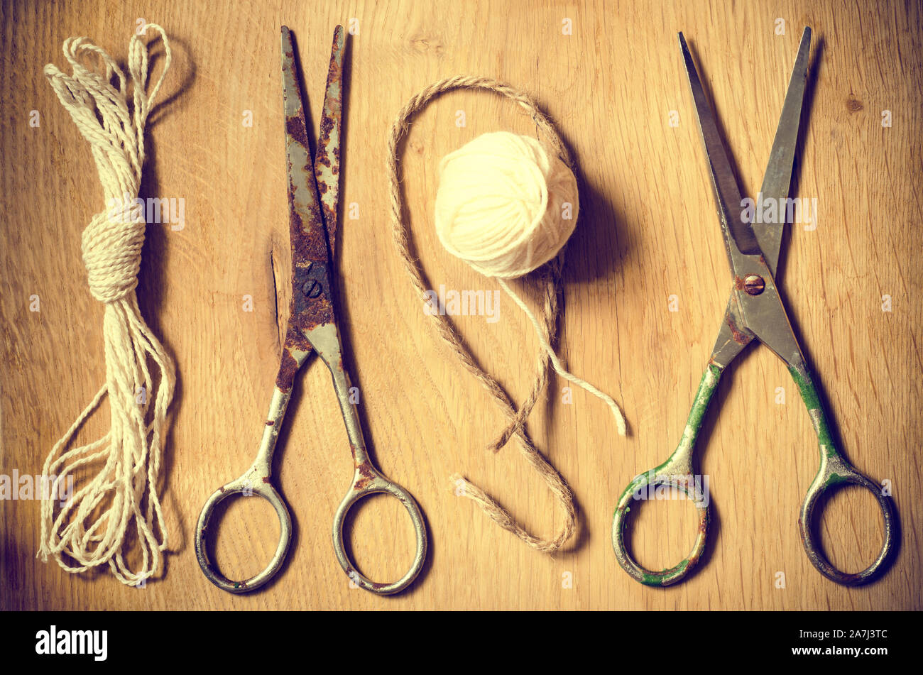 old sewing tools thread and rusty scissors Stock Photo - Alamy