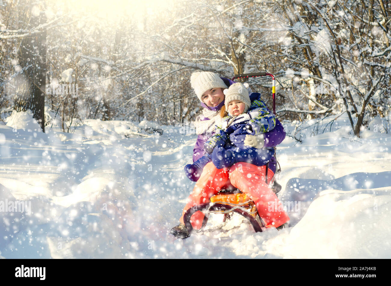 mother and baby sitting on the sledge Stock Photo - Alamy