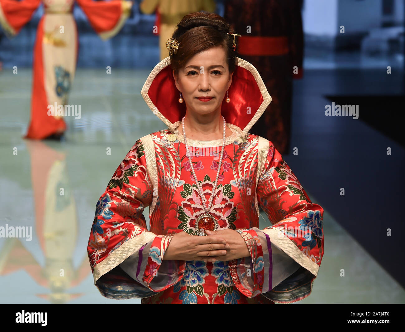 Elder models wearing traditional Chinese outfit designed by Chen Fumei ...