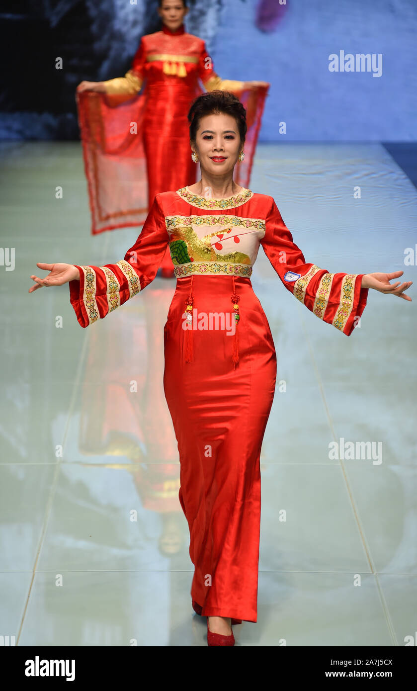 Elder models wearing traditional Chinese outfit designed by Chen Fumei ...