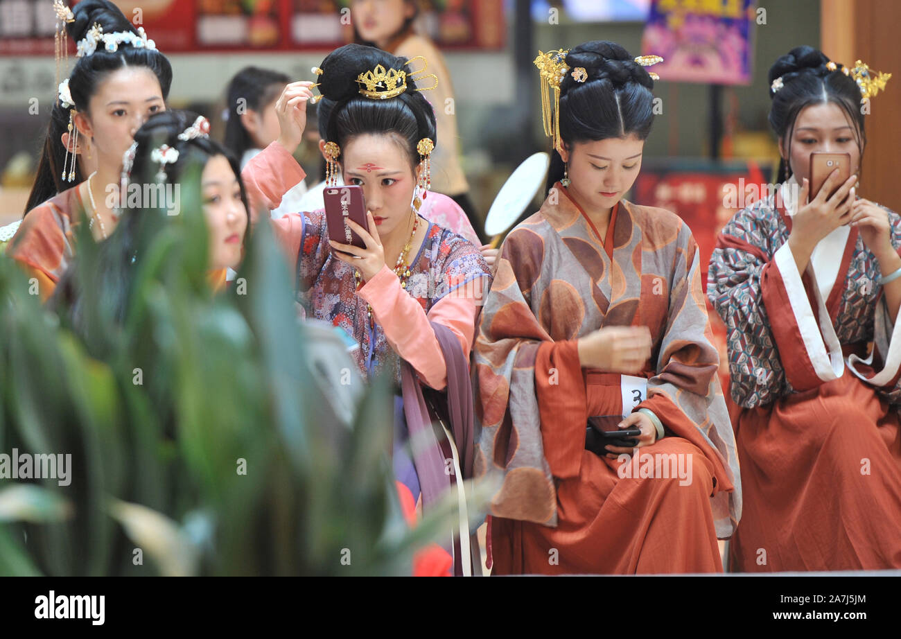 Beauties dressing in ancient Chinese clothes prepare to demonstrate and ...
