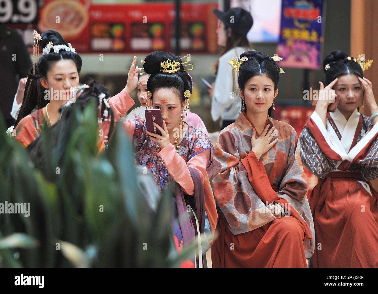 Beauties dressing in ancient Chinese clothes prepare to demonstrate and ...