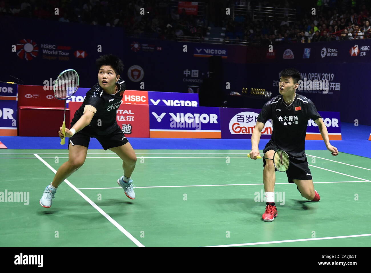 Chinese professional badminton players Zheng Siwei and Huang Yaqiong compete against Chinese ...