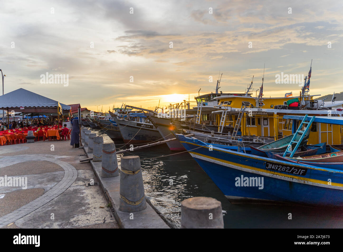 seaside view of a fish market with boats lining up Stock Photo - Alamy