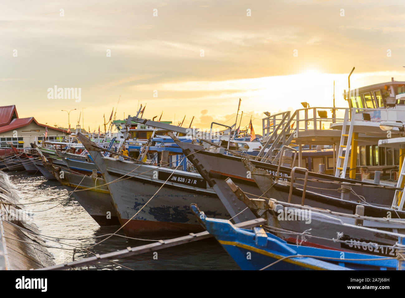 seaside view of a fish market with boats lining up Stock Photo - Alamy