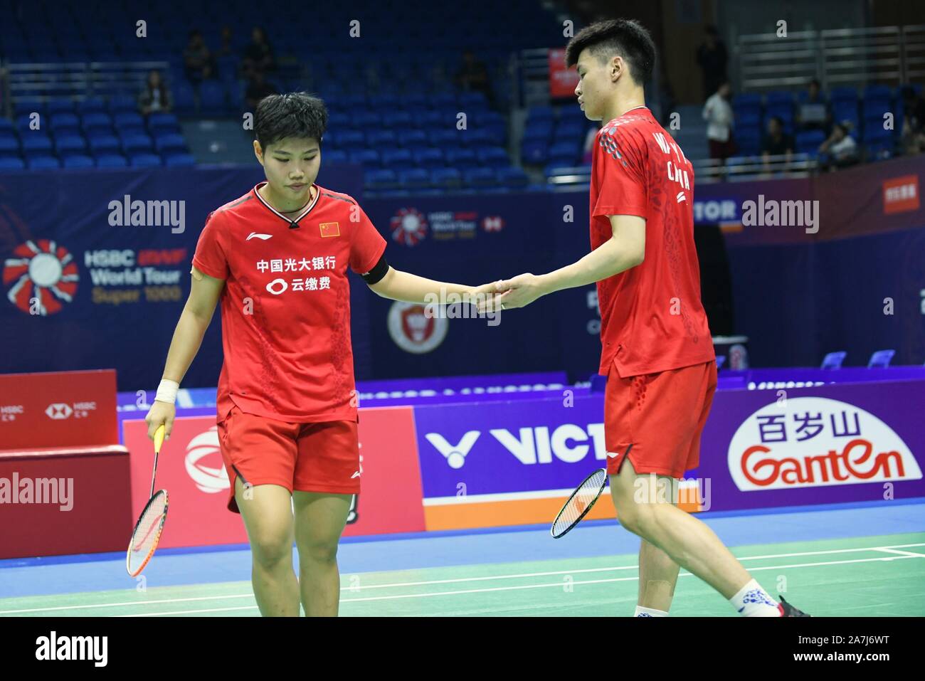 Chinese professional badminton players Wang Yilv and Huang Dongping ...