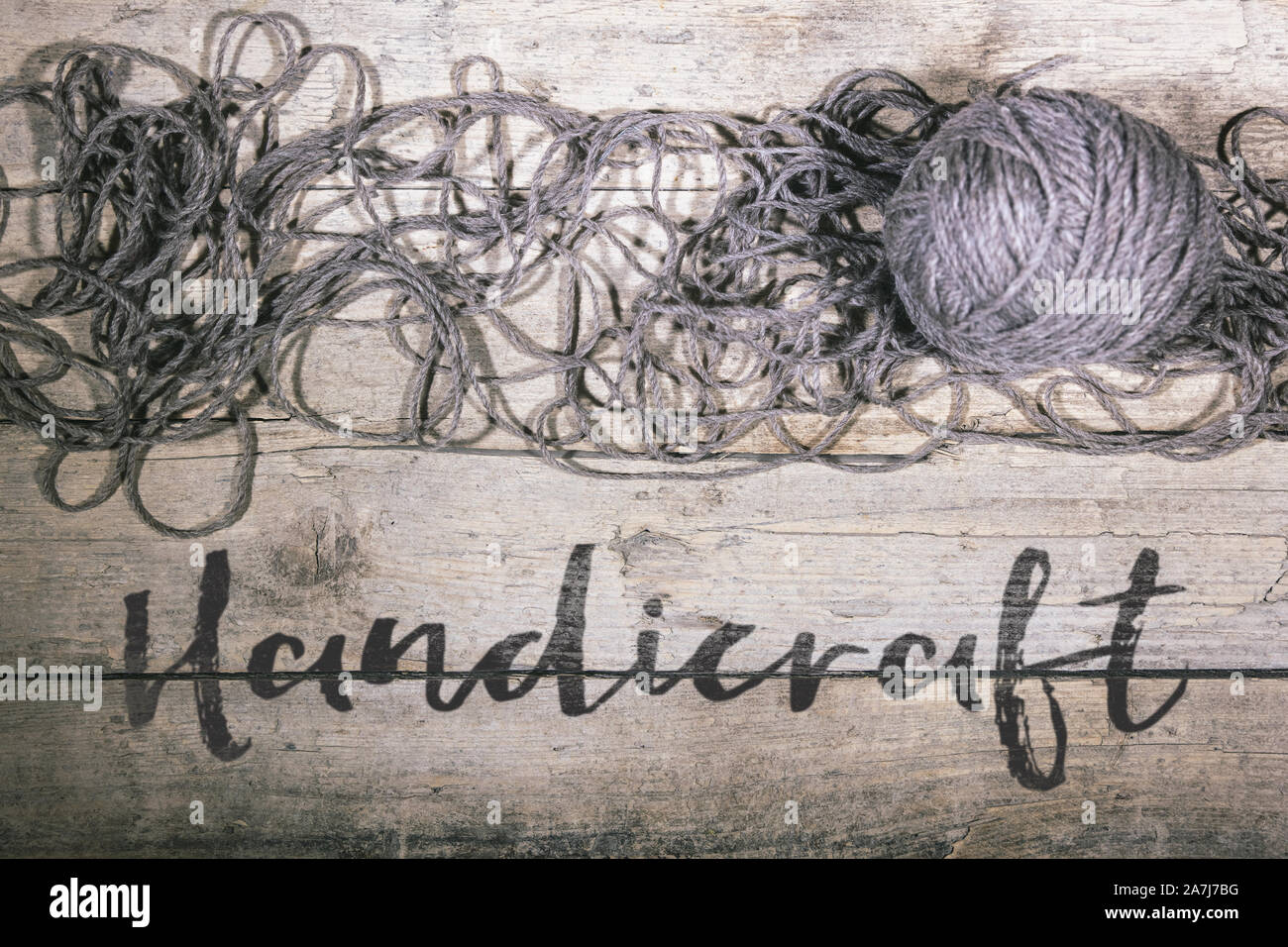 woolen ball and strings on wooden background, word handicraft Stock ...