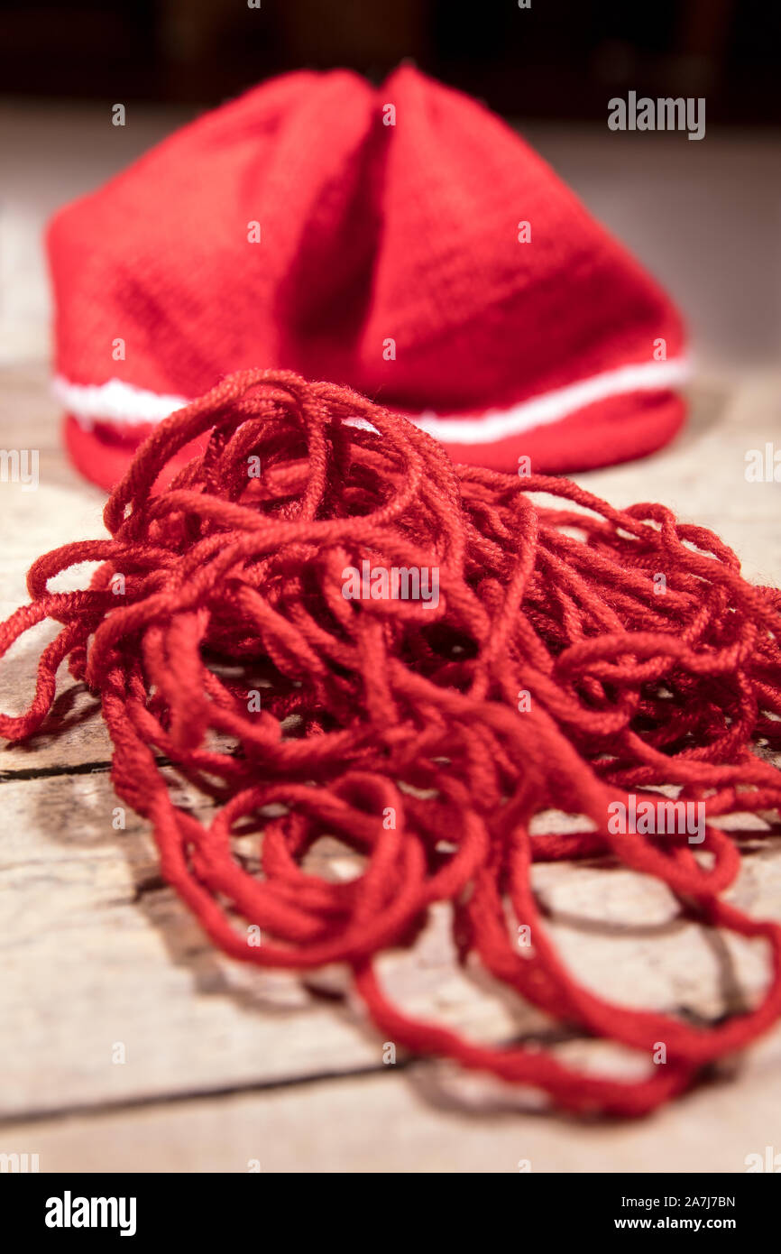 red yarn, woolen string and beanie, knitting and crochet handiwork ...