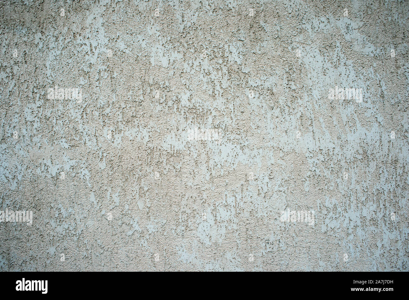 The wall of the building with a mottled surface of clay stucco gray ...