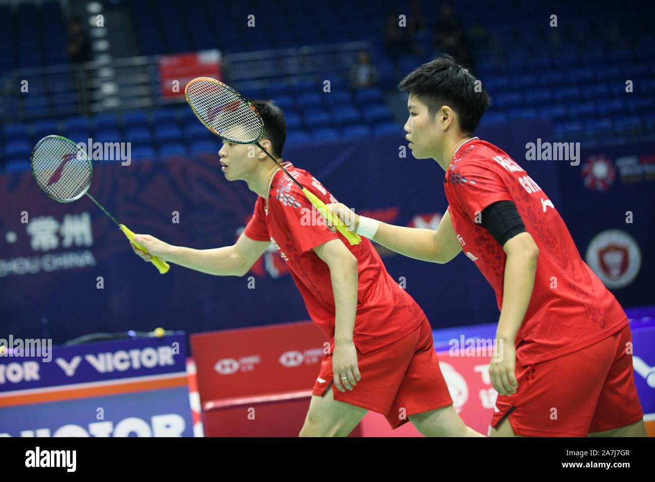 Chinese professional badminton players Wang Yilv and Huang Dongping compete against Japanese ...