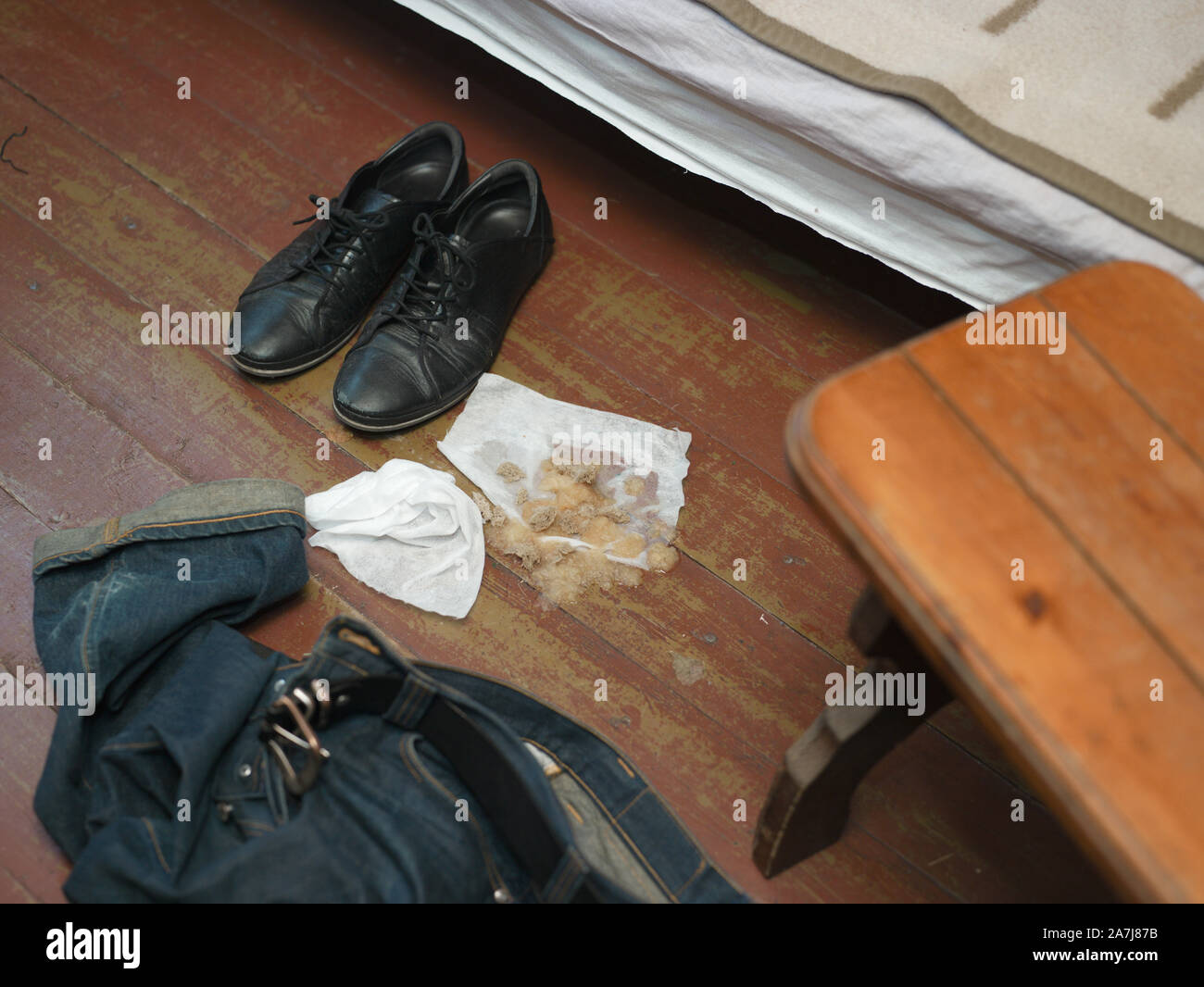 Messy room with vomit and clothing abandoned on the floor Stock Photo ...