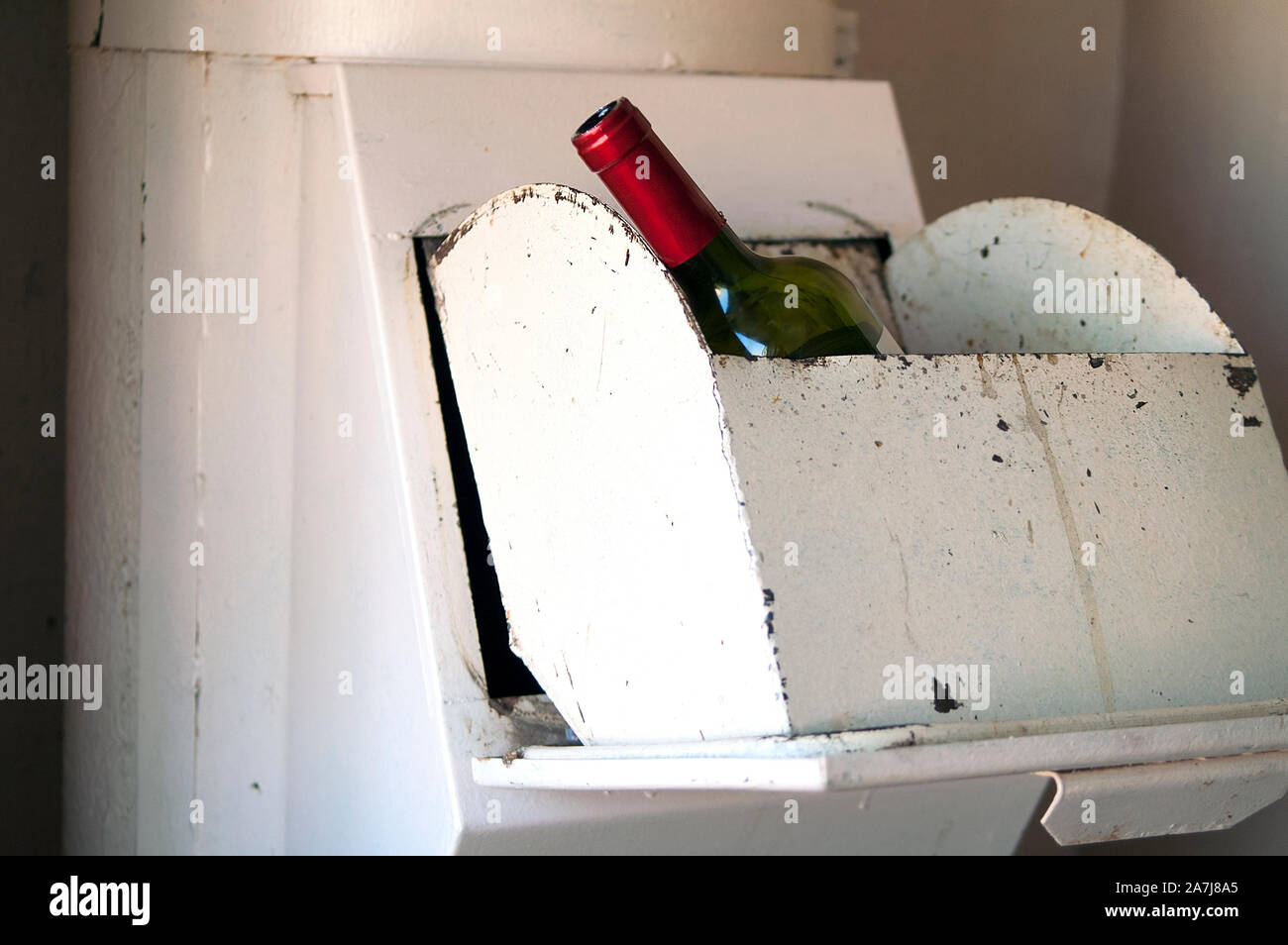 Close-up indoor shot of a wine bottle in a garbage chute Stock Photo ...