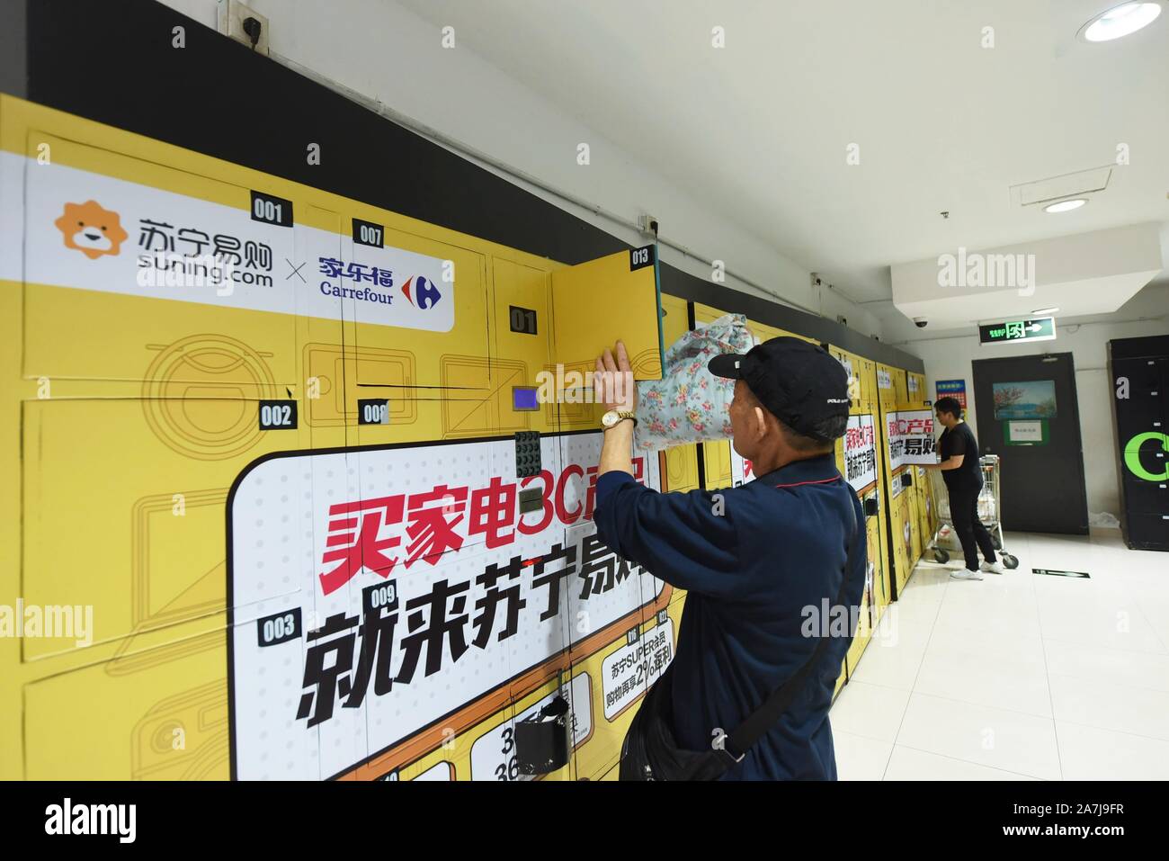 Customers put personal belongings in the self-deposit locker at a newly ...