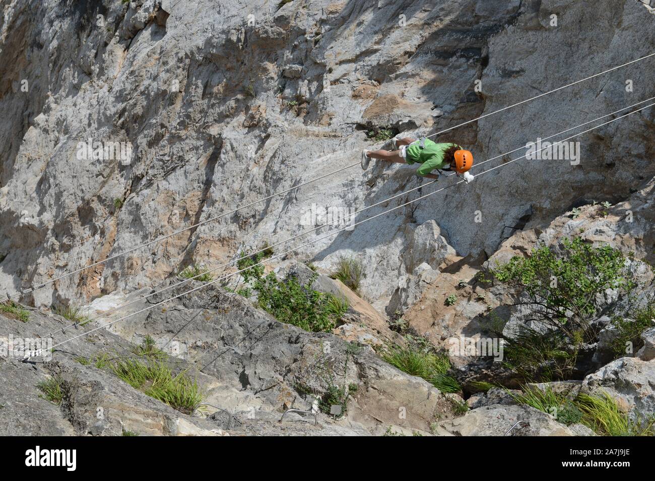 Tourists climb the Cloud Bridge, part of the Via Ferrata project, at ...
