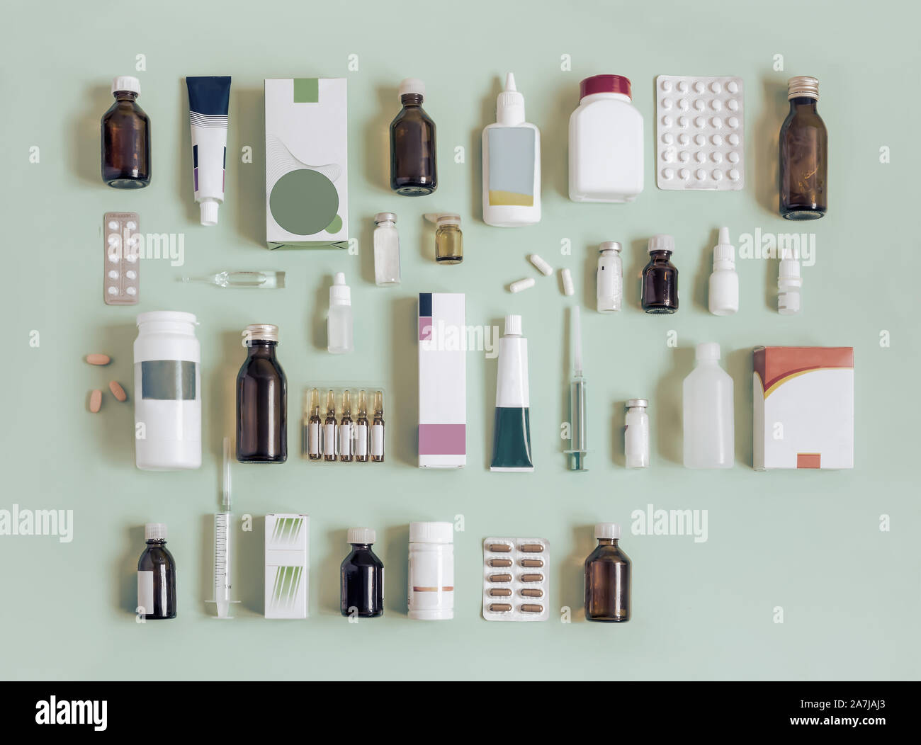 Various forms of medicines on a light green background Stock Photo - Alamy