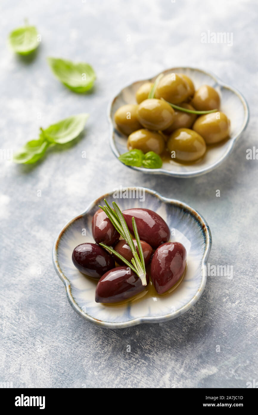 Kalamata and Green Olives on bright wooden background. Close up Stock ...