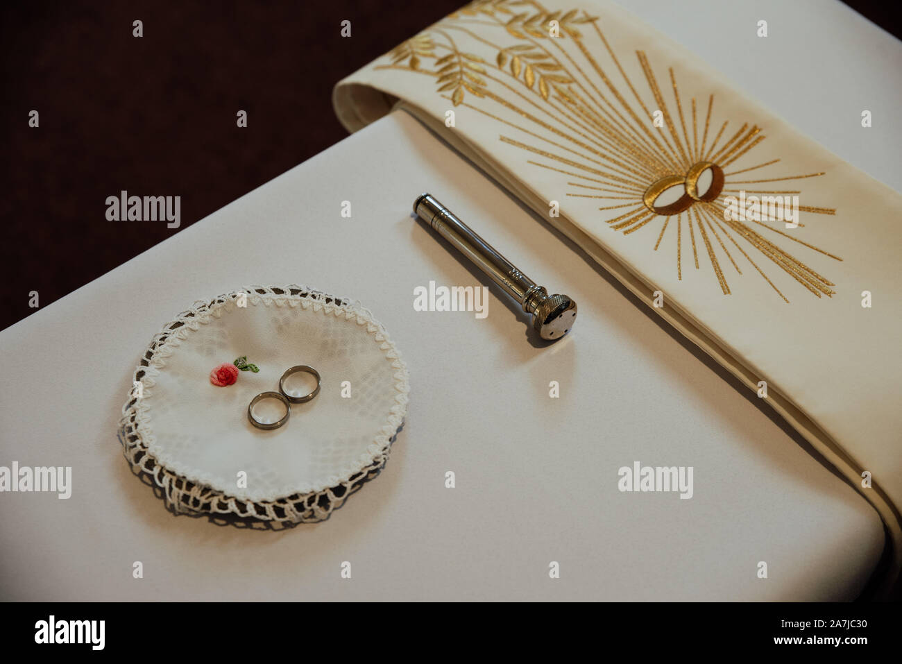 wedding rings in church with tools for ordination Stock Photo - Alamy