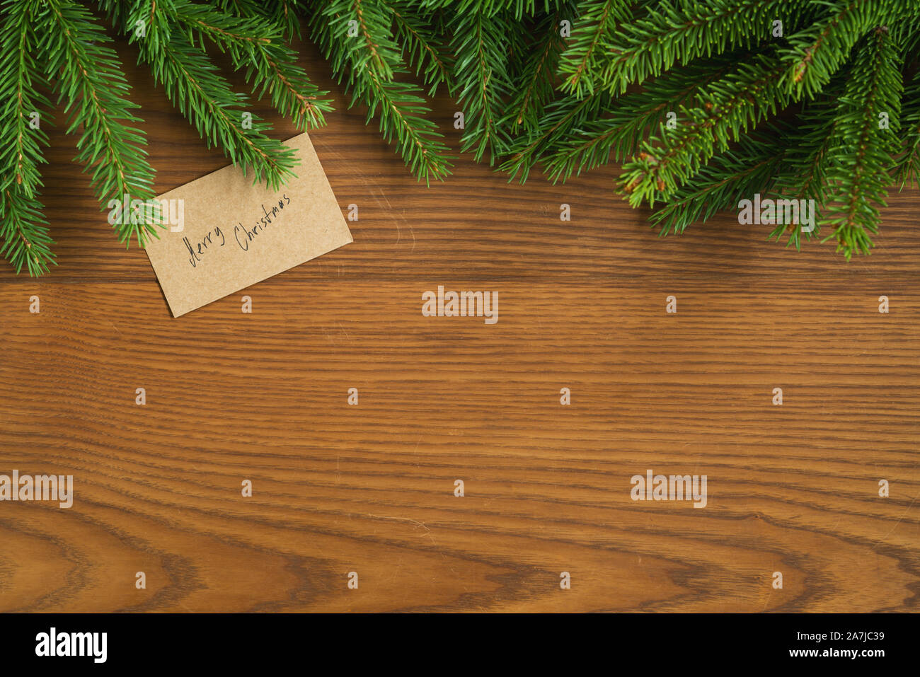 Flat lay christmas background with spruce twigs and merry christmas ...