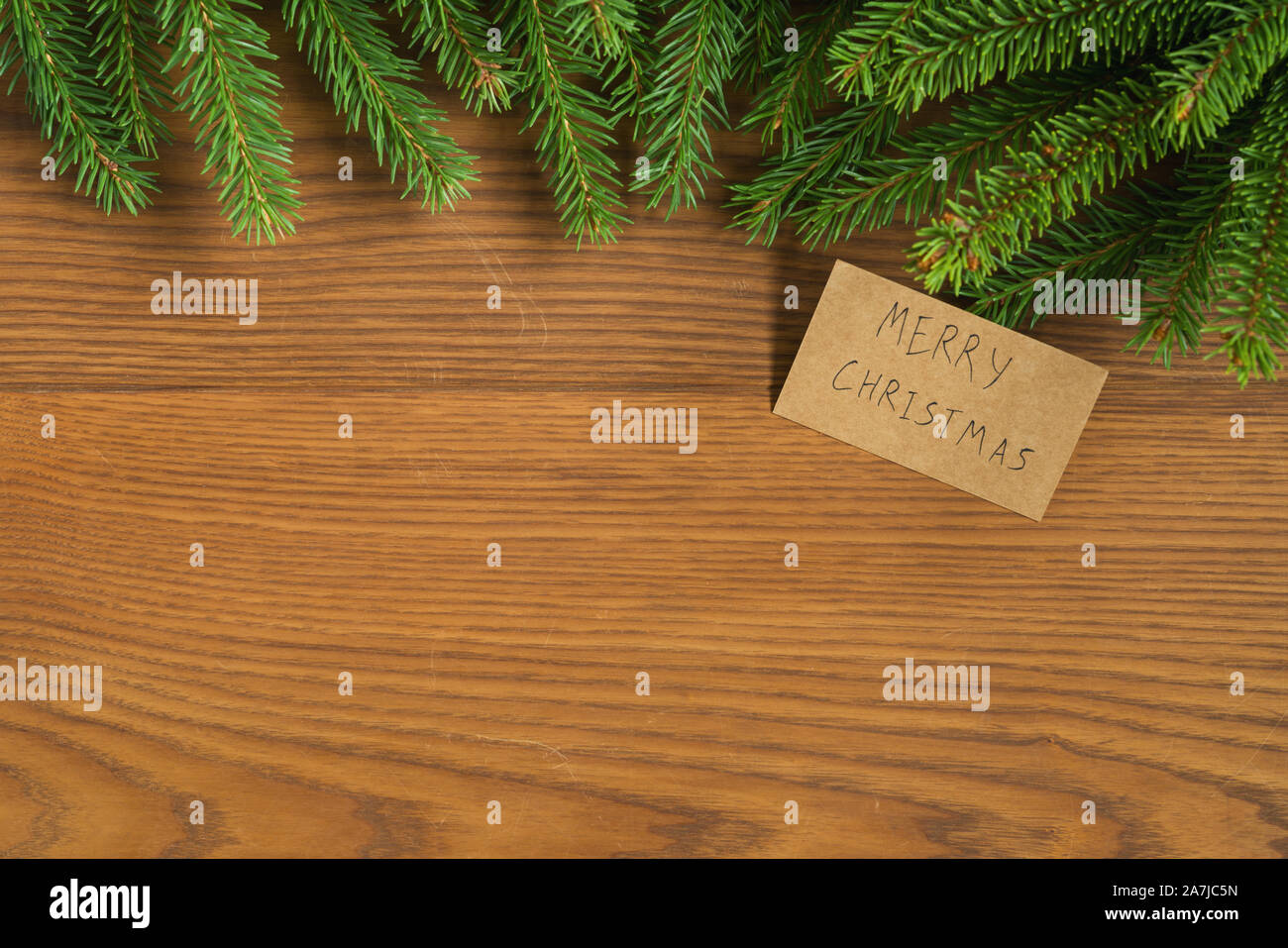 Flat lay christmas background with spruce twigs and merry christmas ...