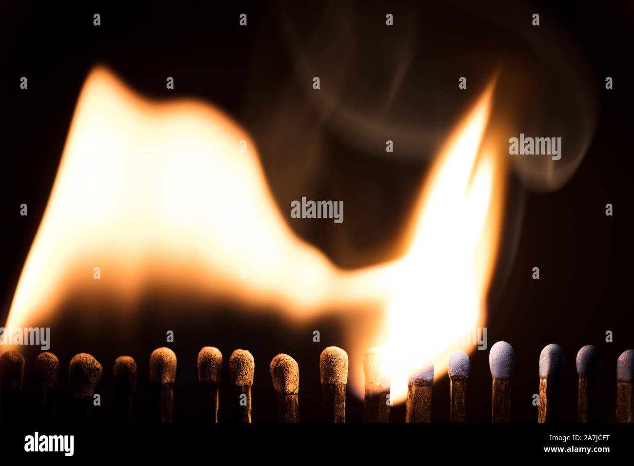 Matchsticks are burning, chain reaction with fire and flames, black ...