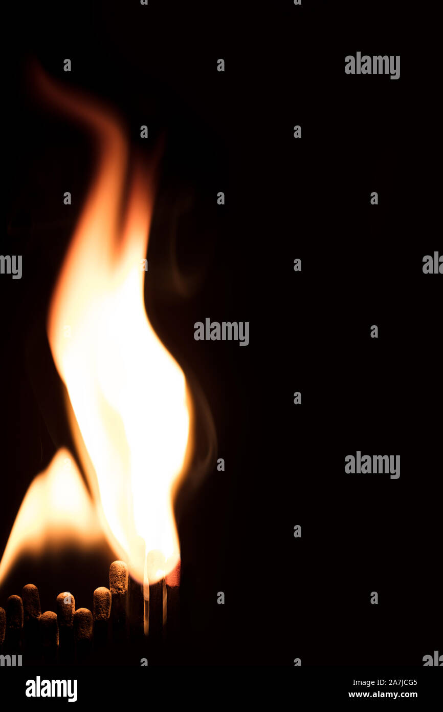 burning matches and a big flame of fire, black background and copyspace ...