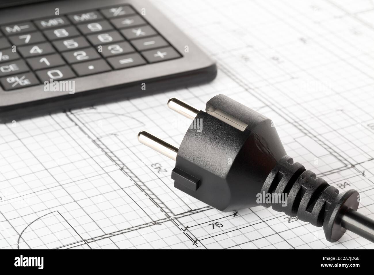 Power cord, plug and calculator on building construction blueprint plan ...