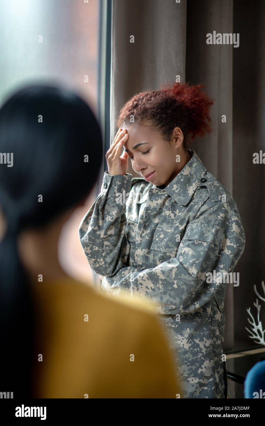 Young servicewoman crying while remembering hard moments Stock Photo ...