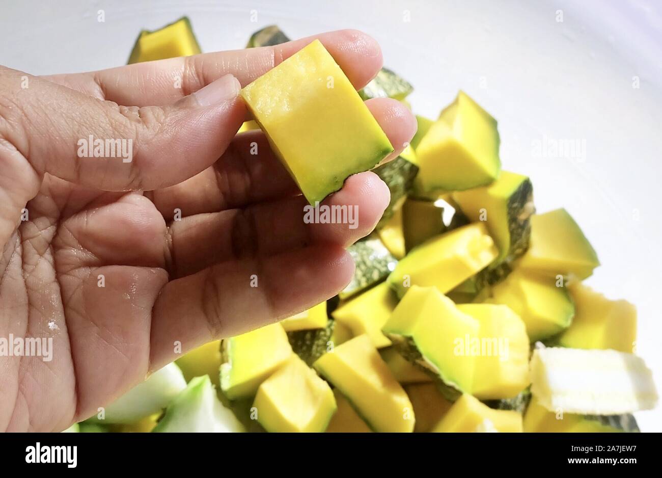 Vegetable, Hand Holding Raw Chopped Angled Gourds or Sponge Gourds with ...