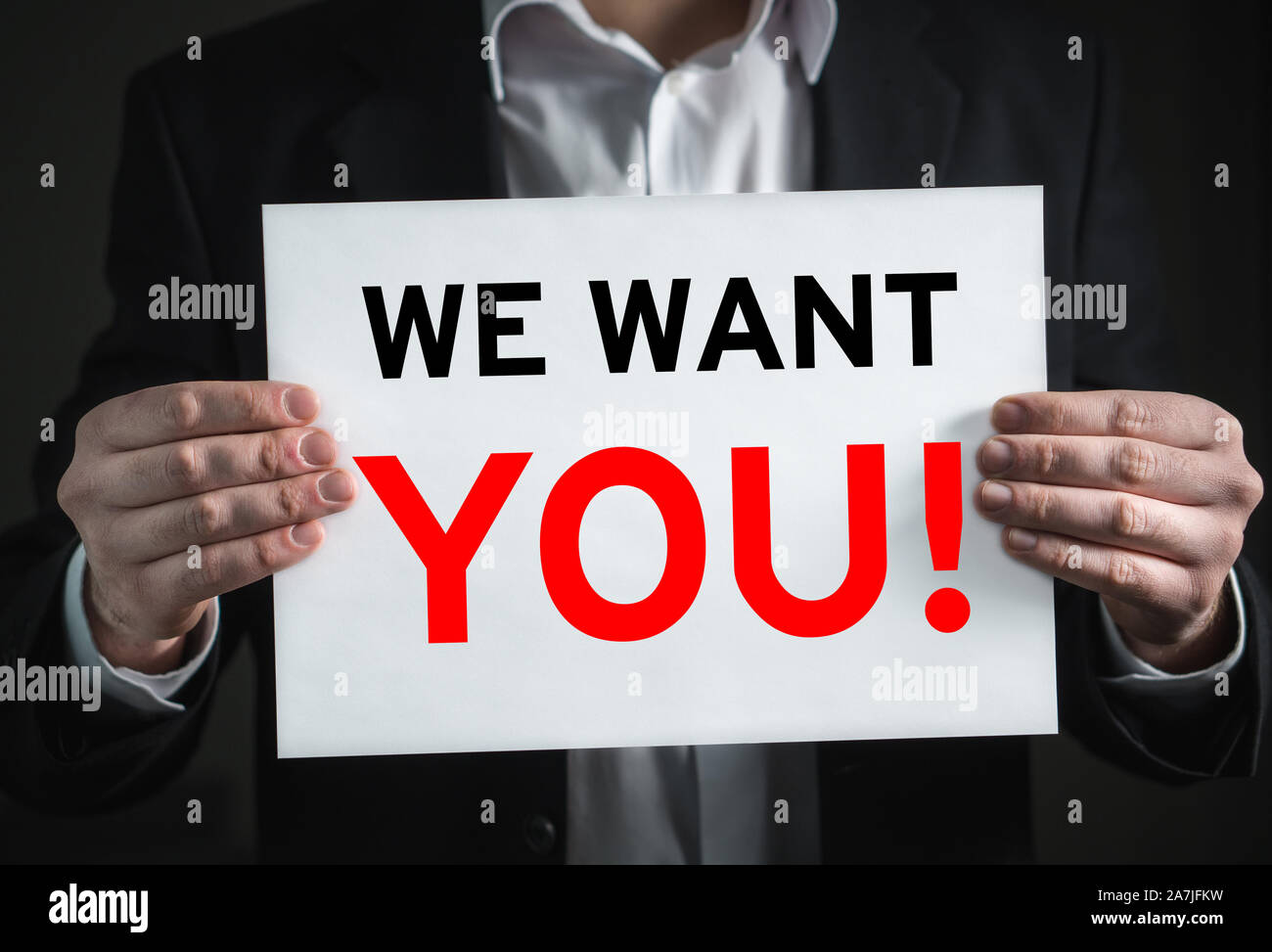 We want you on white card held by businessman closeup Stock Photo - Alamy