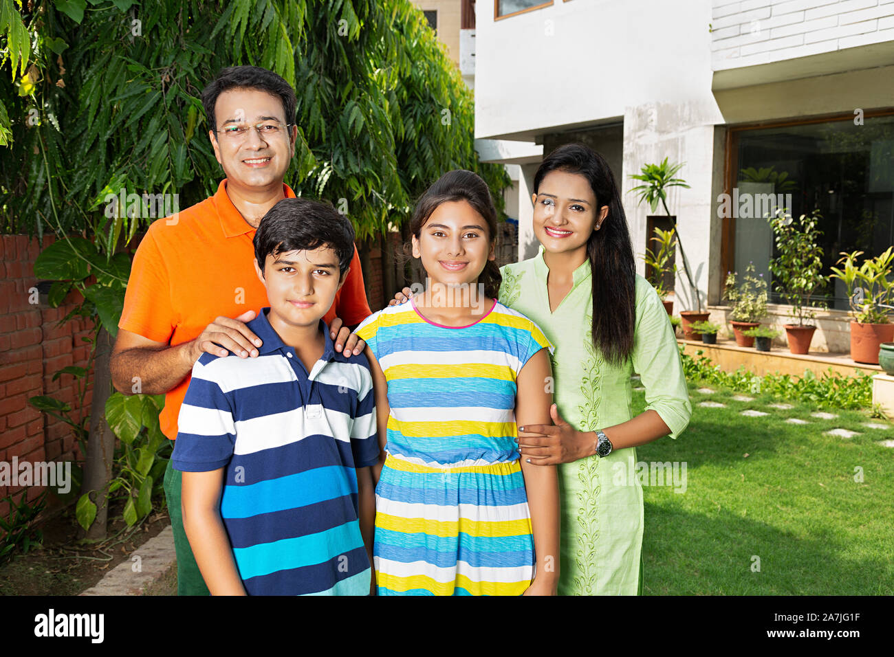 Happy-Family Adult Parents And Young Son With Daughter Standing ...