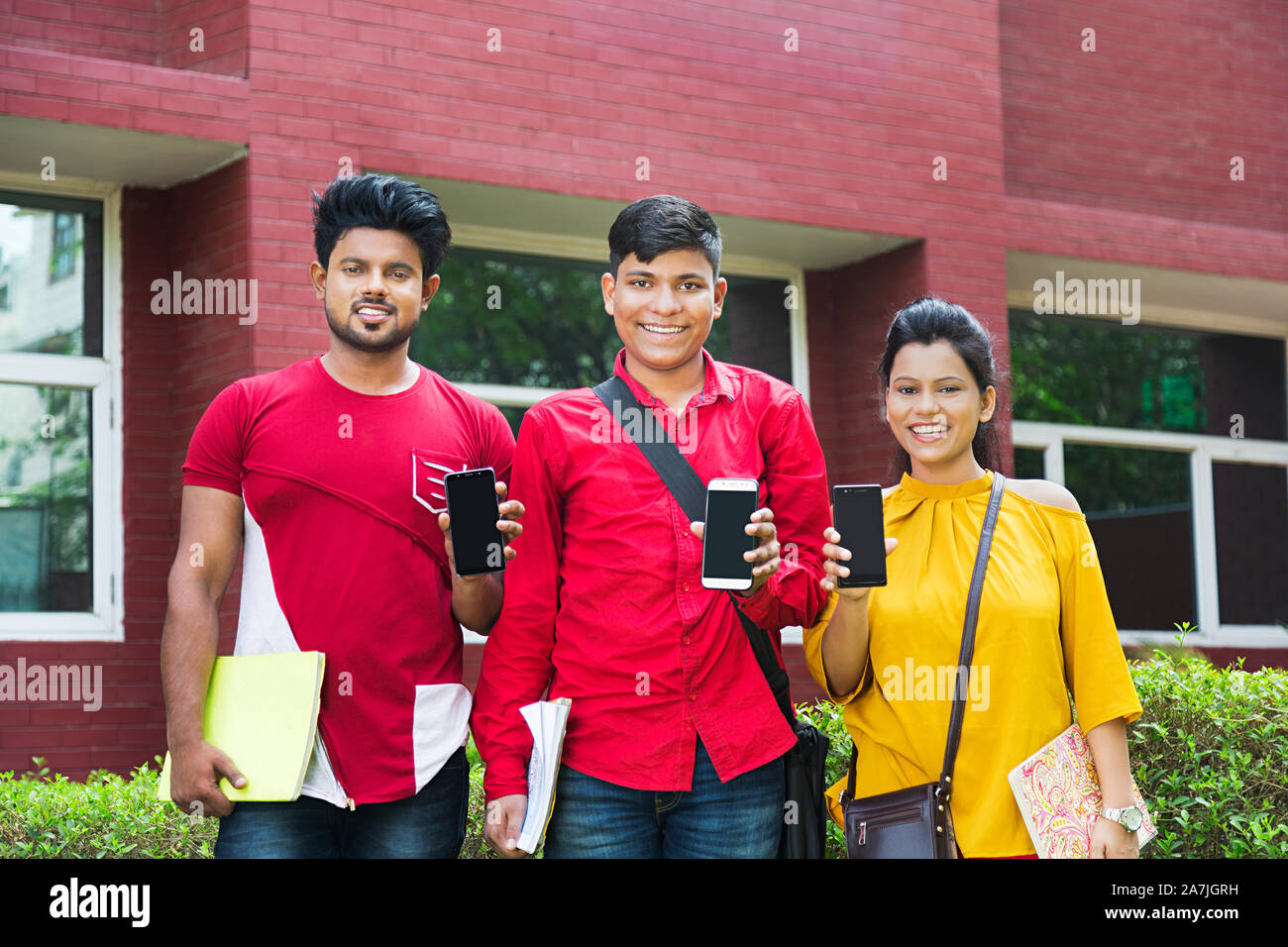 College Boys And girl students Friends Showing Smart-Phone Together In ...
