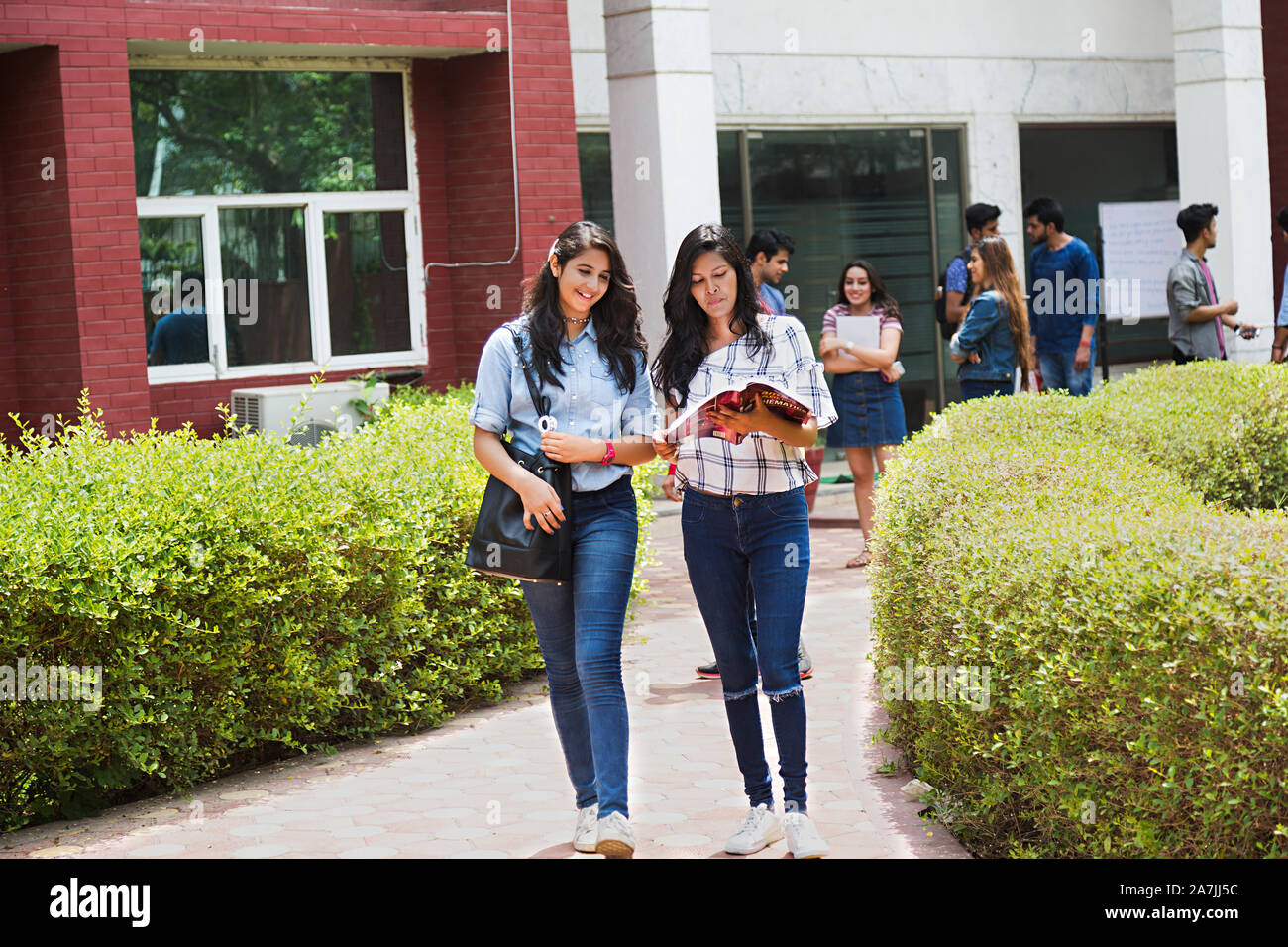 Full-Length of Two College Girls Student Friends Together Reading Book ...
