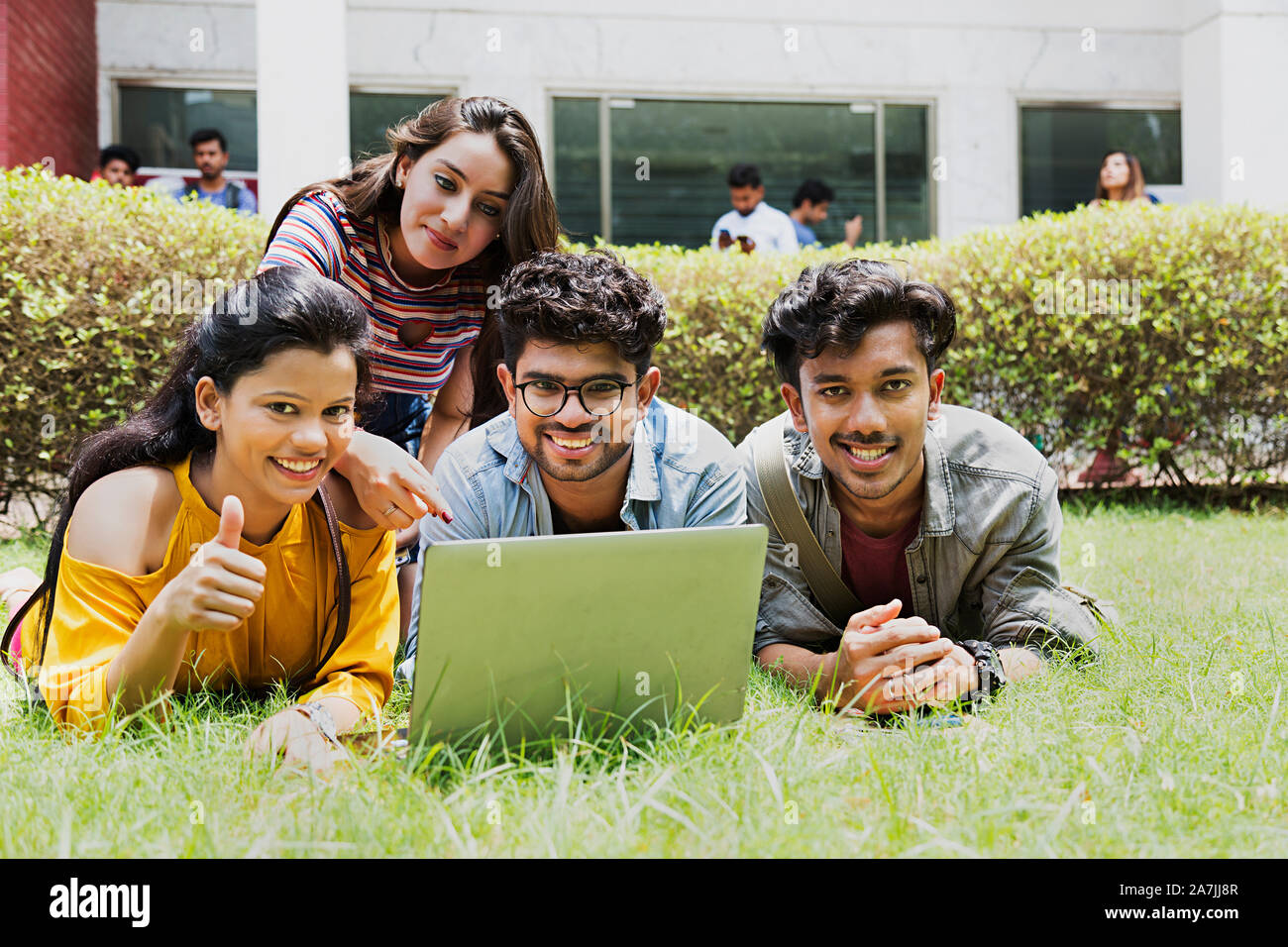 Classmates lying down on grass in park hi-res stock photography and ...